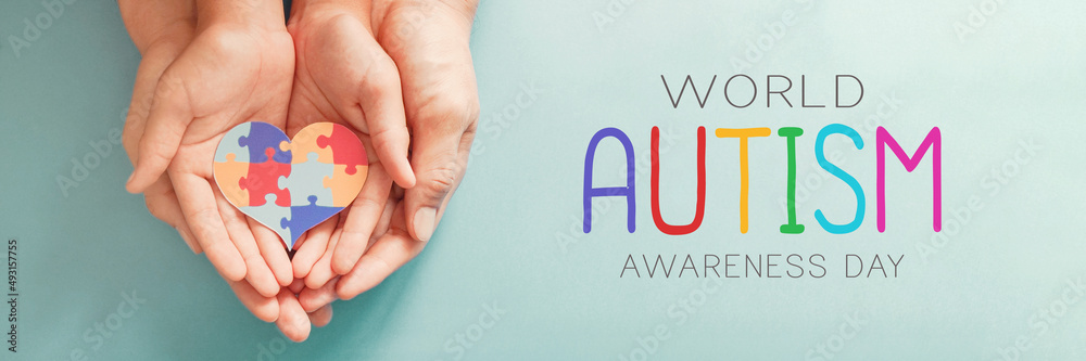 Adult and chiild hands holding jigsaw puzzle heart shape, Autism ...