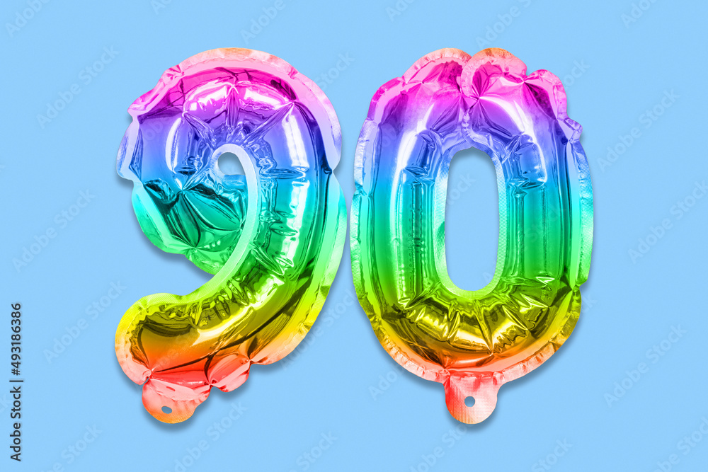 Rainbow foil balloon number, digit ninety on a blue background ...