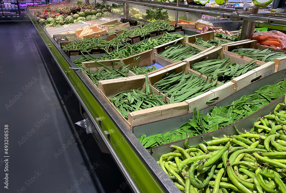 counters in a supermarket with vegetables and fruits. Shopping in a ...