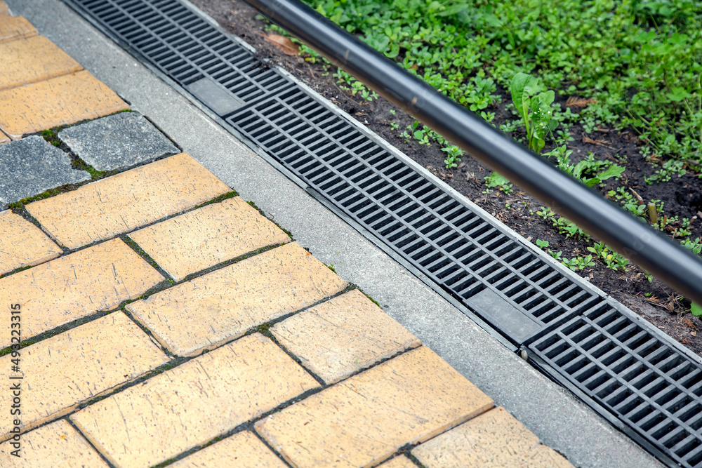 iron grating of the drainage system for drainage of rainwater in the ...
