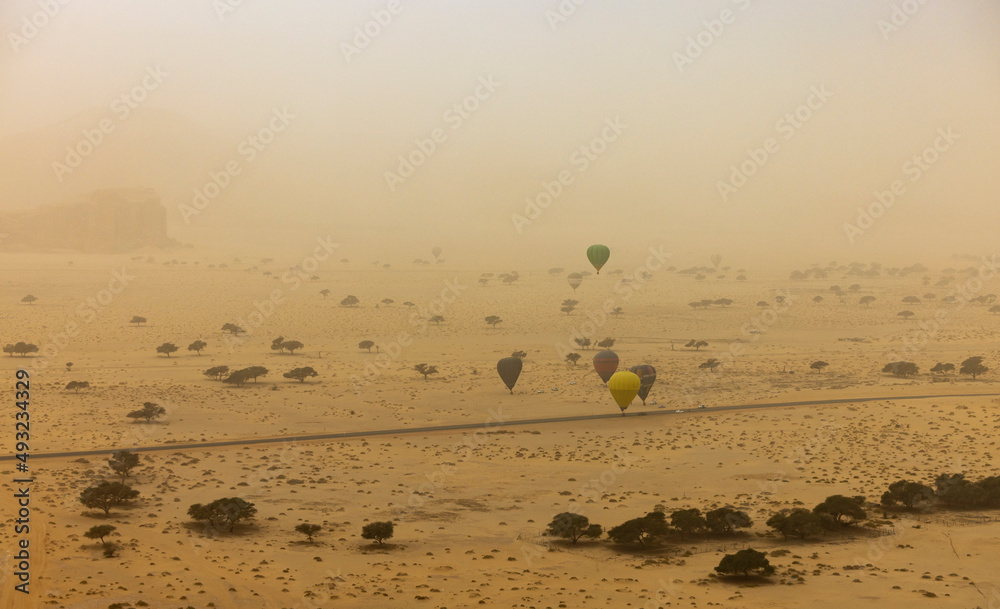 Sunrise balloons in flight over the north west Saudi Arabian desert ...