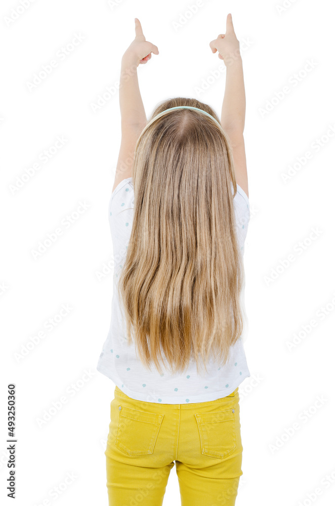 Back view of little girl pointing up at wall. Adorable girl standing ...