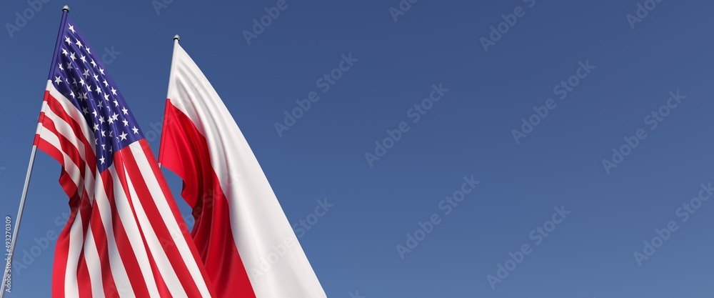 Flags of the USA and Poland on flagpoles on side. Flags on a blue ...
