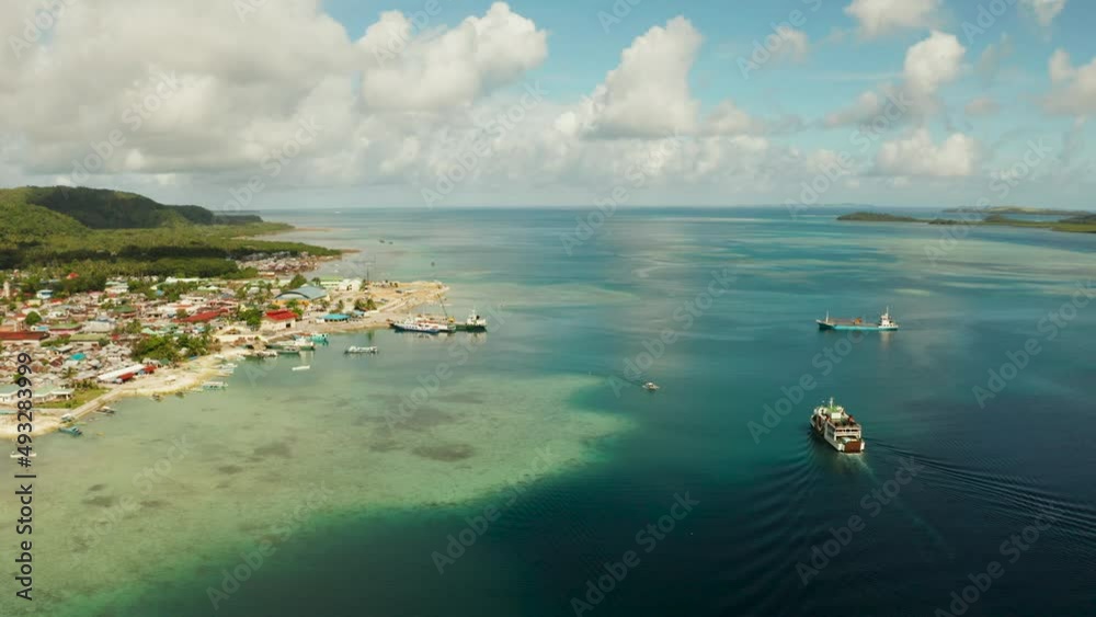 Passenger port with ferries and cargo ships on the island of Siargao ...