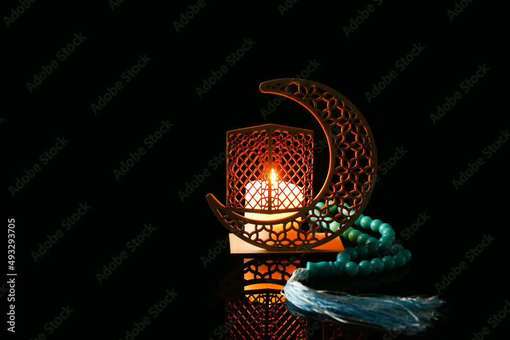 Arabic candle holder with glowing candle and tasbih on dark background ...