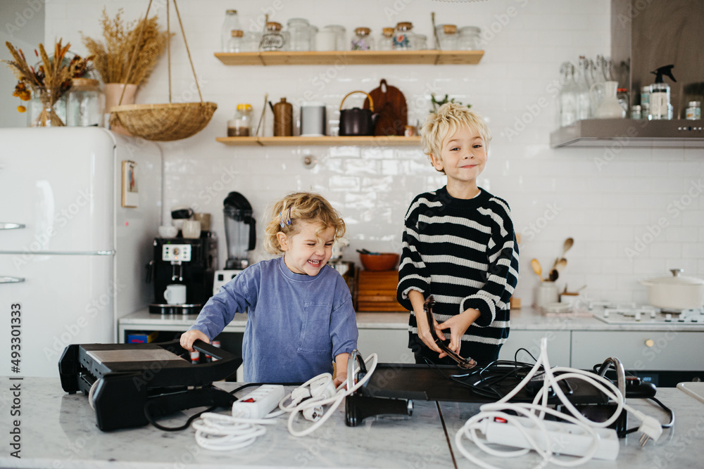 Cute kids playing with electronic products at home Stock Photo | Adobe ...