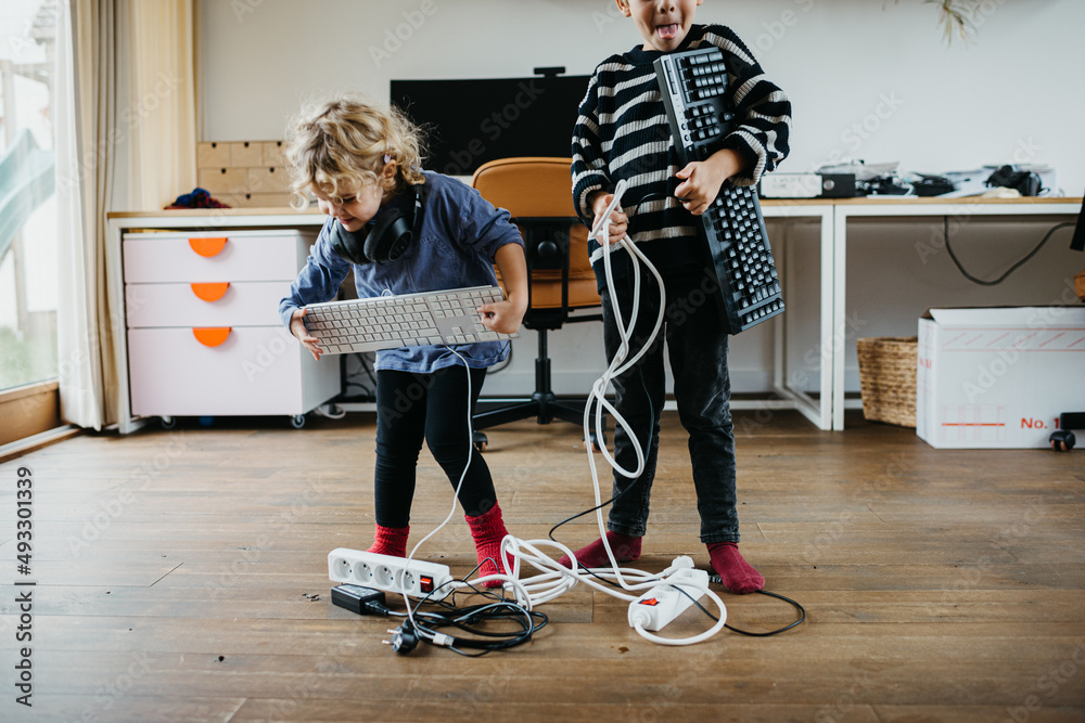 Kids playing with electronic devices at home Stock Photo | Adobe Stock