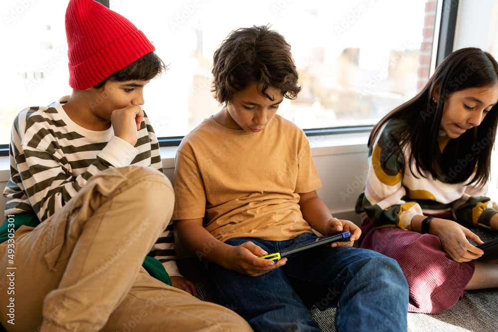 Children playing with electronics devices in apartment Stock Photo ...