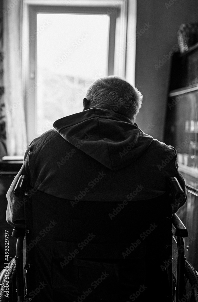 Physically disabled man sitting in his wheelchair Stock Photo | Adobe Stock