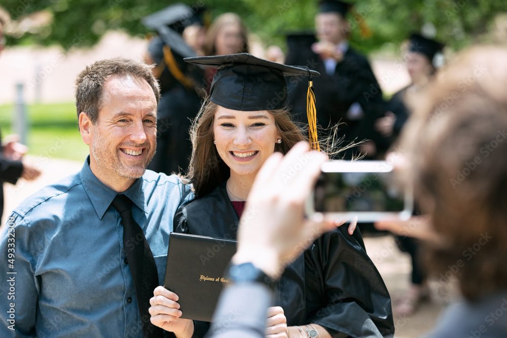 Grad: Parent And Child Pose For Photograph With Diploma Stock Photo ...