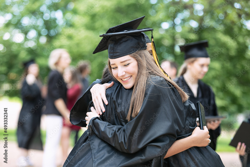 Grad: Friends Embrace After Graduating Stock Photo | Adobe Stock