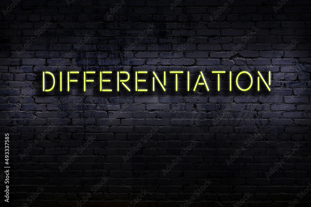 Neon sign. Word differentiation against brick wall. Night view Stock ...