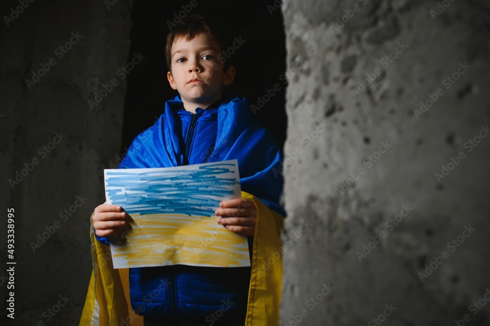 Ukrainian Crying boy holds a painted flag of Ukraine. War of Russia ...