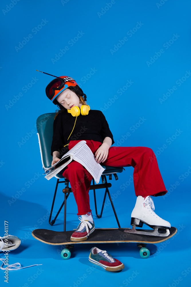 Exhausted multitasking kid sleeping in studio Stock Photo | Adobe Stock