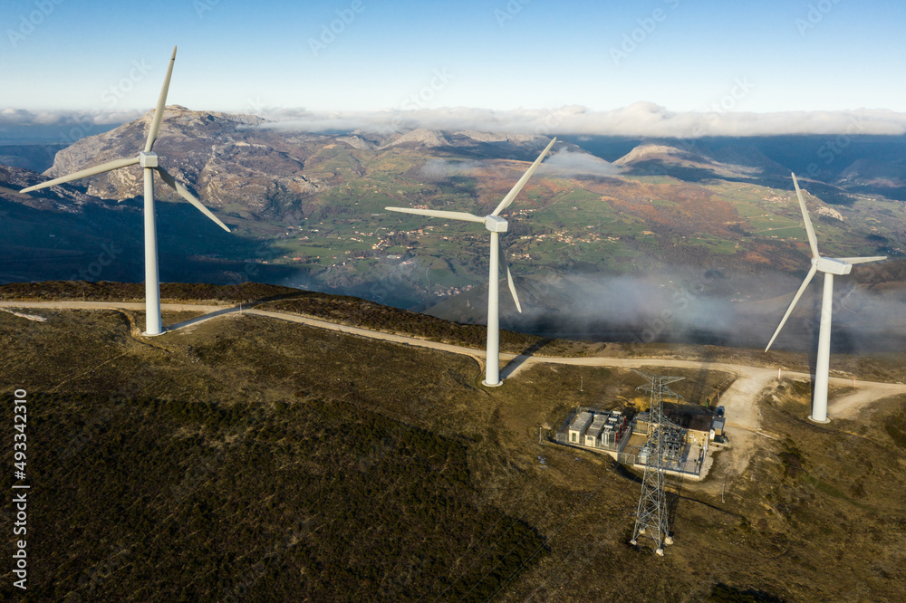 3 windmills and their power station Stock Photo | Adobe Stock