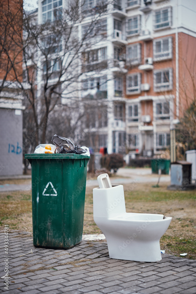 Recycling Bin And Broken Toilet Outside Stock Photo | Adobe Stock