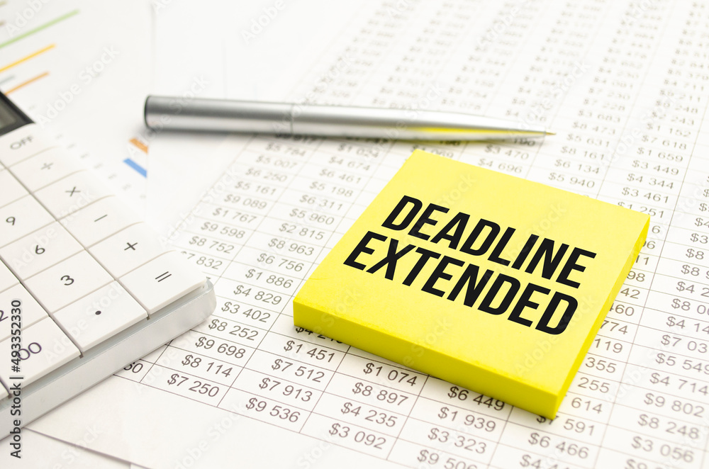 Business concept.Text DEADLINE EXTENDED with magnifying glass ...