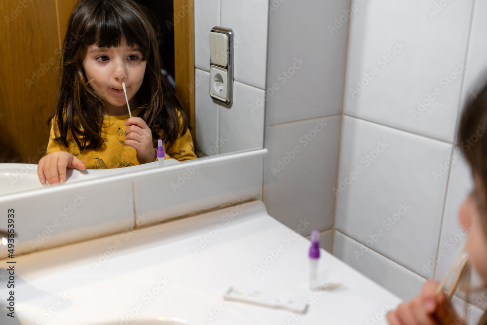 Little girl doing Covid antigen test Stock Photo | Adobe Stock