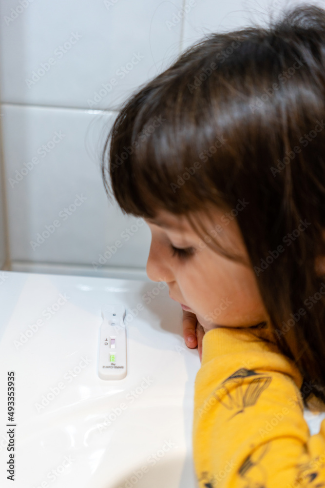 Little girl doing Covid antigen test Stock Photo | Adobe Stock