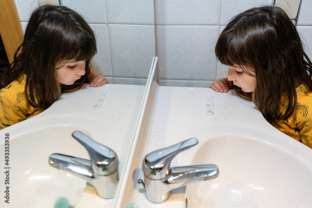 Little girl doing Covid antigen test Stock Photo | Adobe Stock