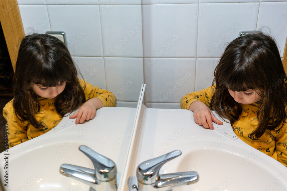 Little girl doing Covid antigen test Stock Photo | Adobe Stock