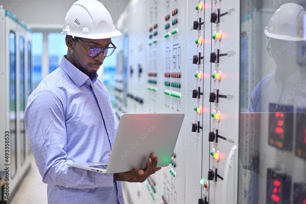 Engineer man with laptop in production control room Stock Photo | Adobe ...