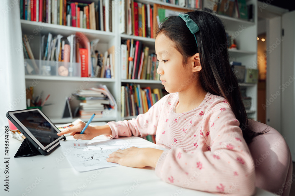 Cute girl studying at home Stock Photo | Adobe Stock