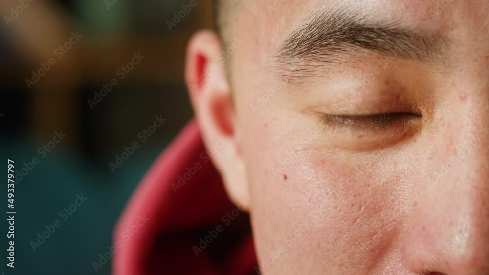 Asian man eyes close-up. Half-face portrait of Korean young guy ...