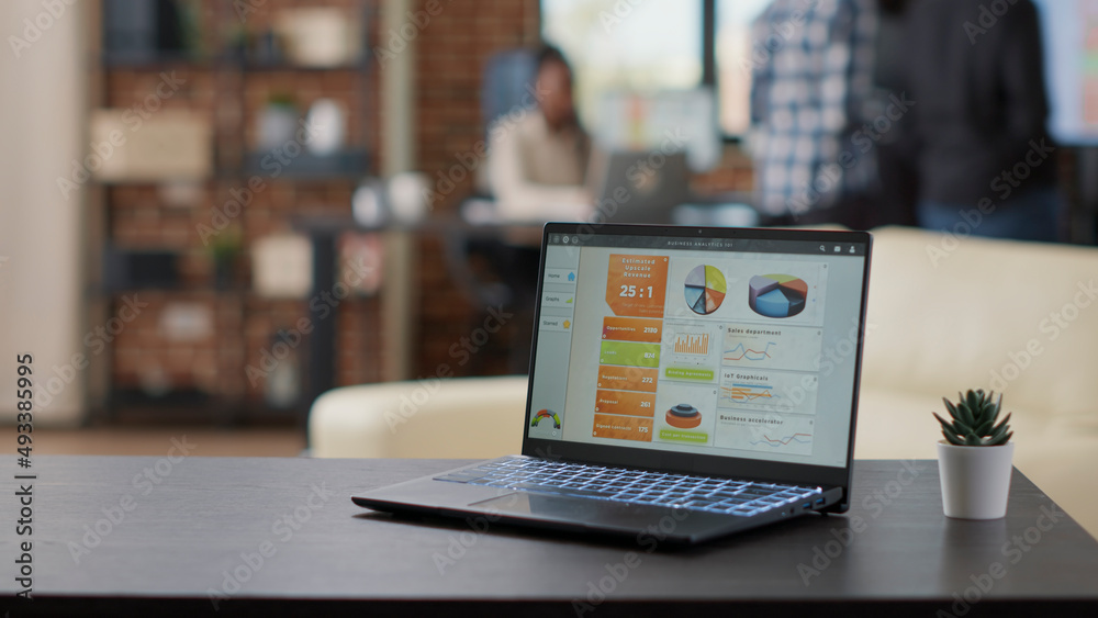 Laptop screen with financial charts and graphs on office desk, computer ...