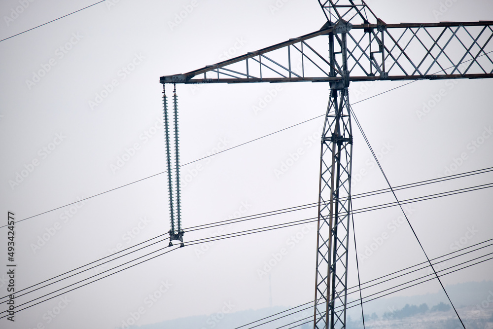 High voltage tower with electric power lines divided by safe guard ...