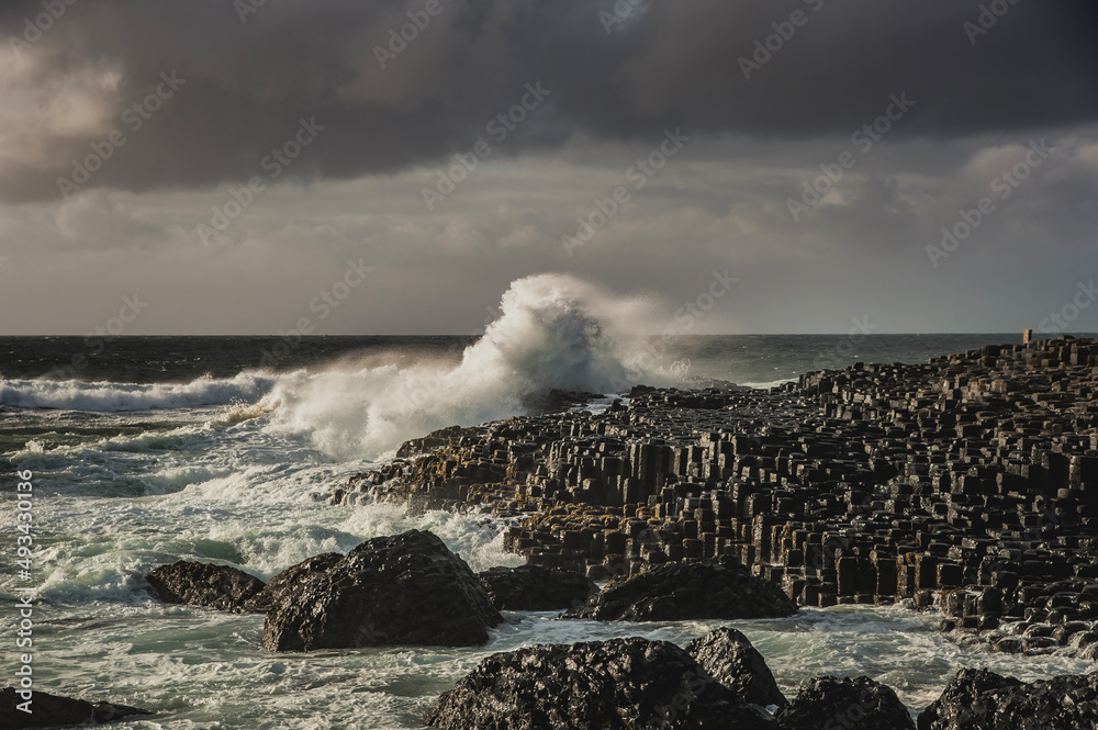 Rough ocean waves smashing on hexagonal rocks at the giant 's causeway ...