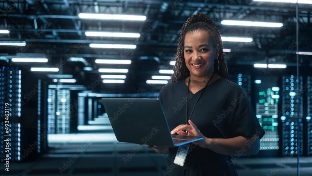 African American Female IT Specialist Using Laptop Computer, Standing ...