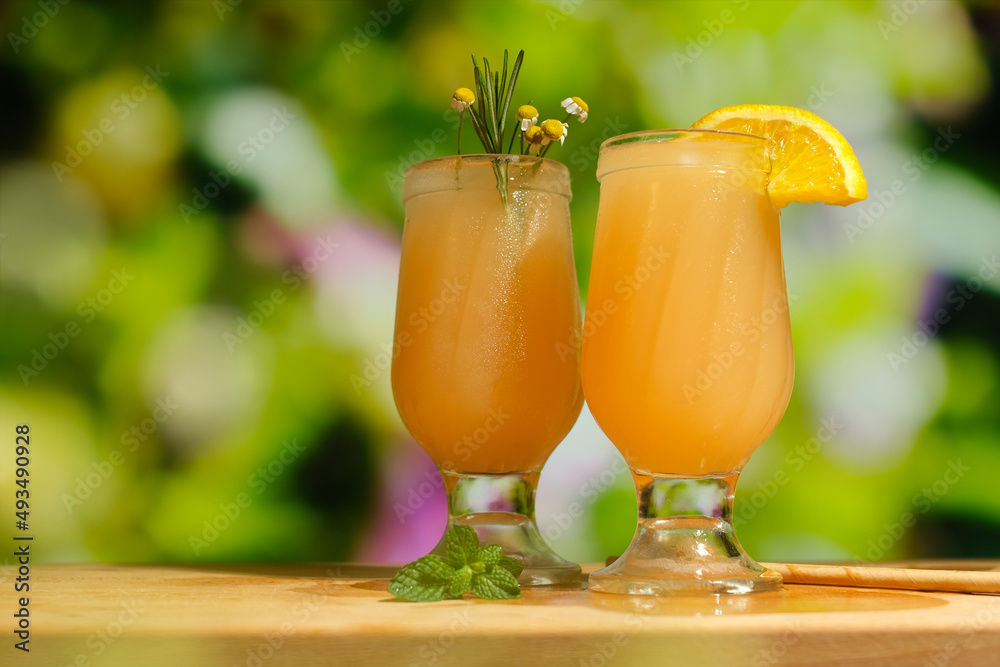 Two fruit summer mocktails outdoors. Stock Photo | Adobe Stock