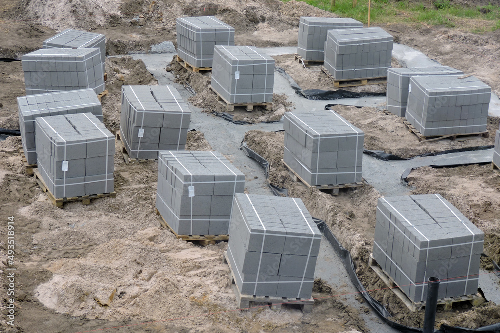Solid concrete blocks on wooden pallets on a construction site ...