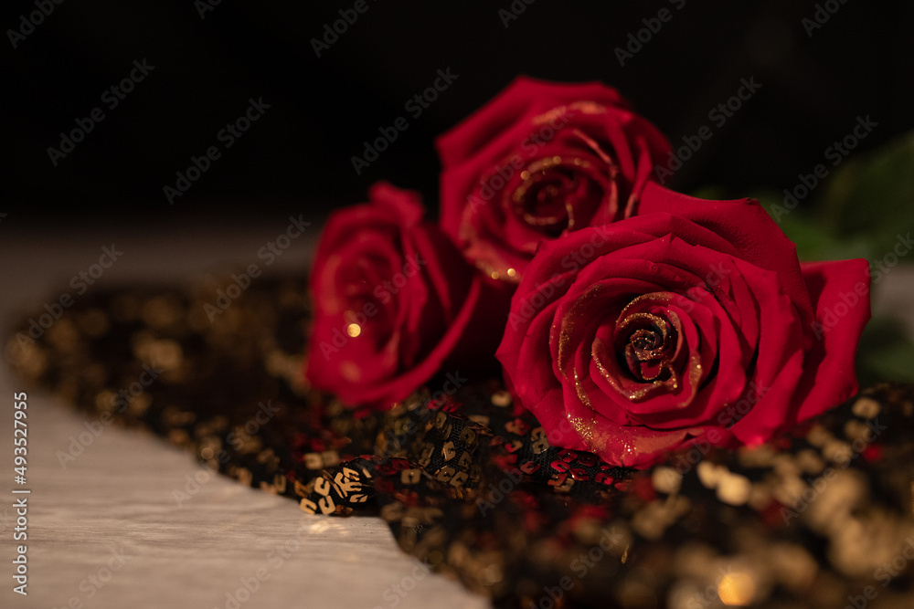 A beautiful photo of a bouquet of red roses with a golden coating on ...