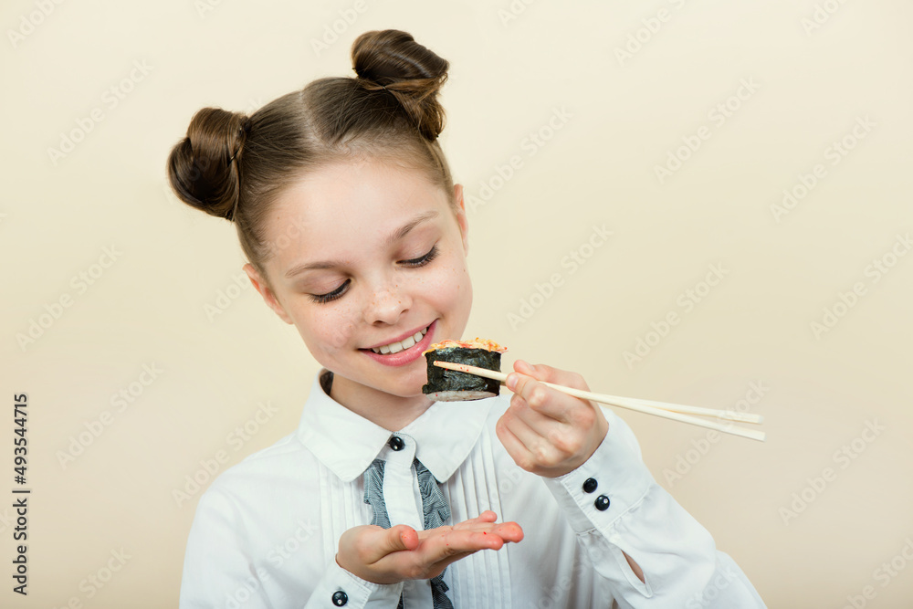 Cute smiling little girl with with sushi on light background. Child ...