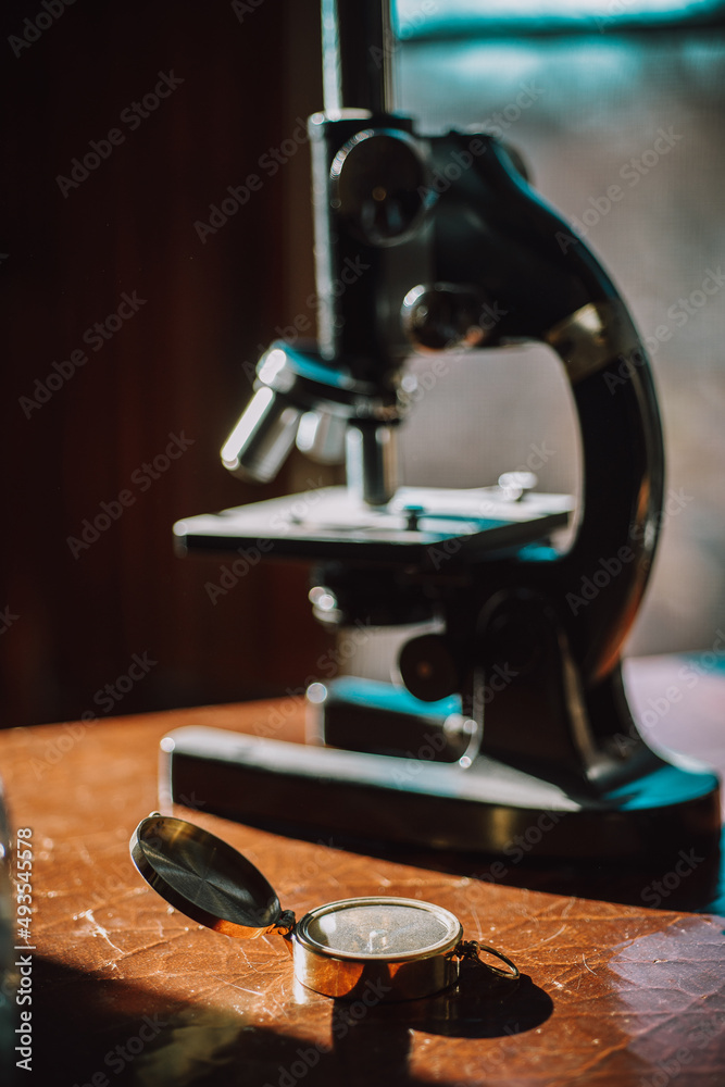 Beautiful vintage antique microscope and compass shot in dramatic ...