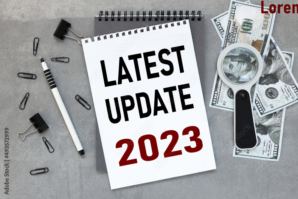 two notepads with text on the table near banknotes and a magnifying ...