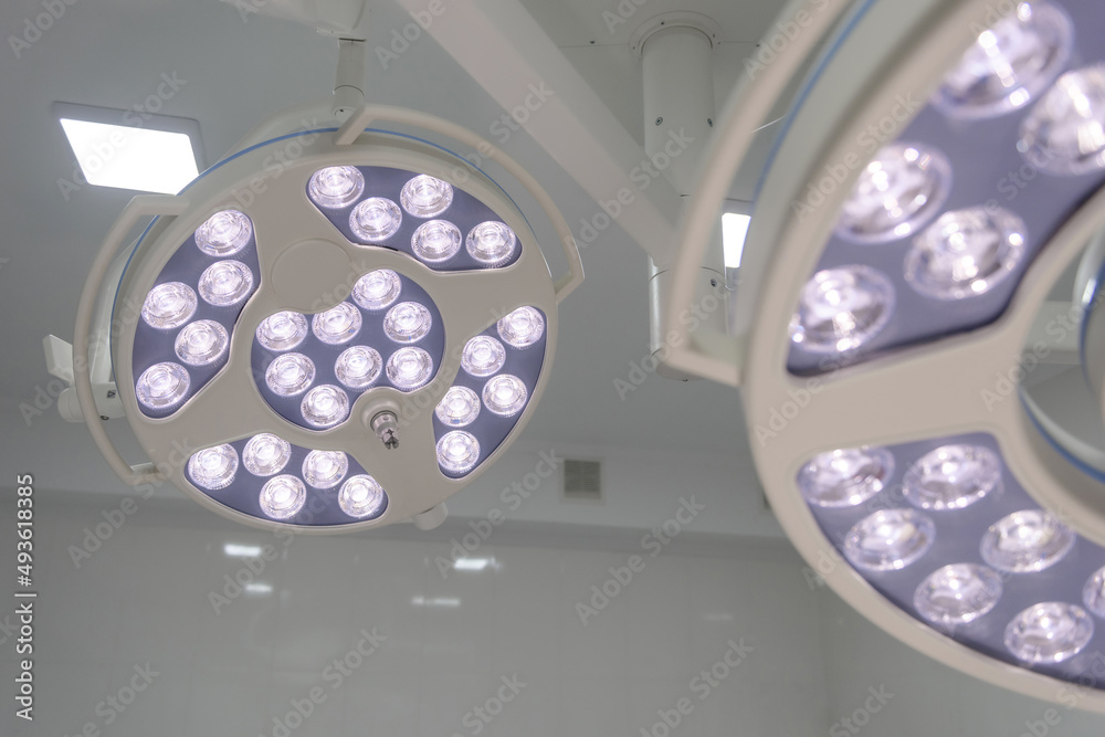 Modern operating unit. LED surgical shadowless lamp shines in the ...