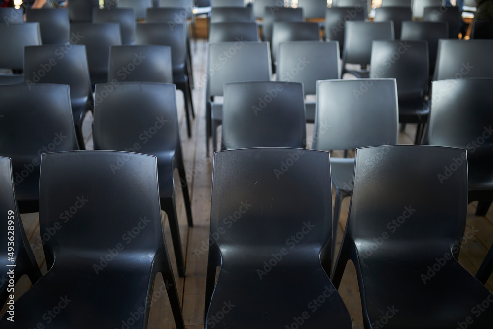 Many Black Chairs in a Row. evocative series of chairs. rows of chairs ...
