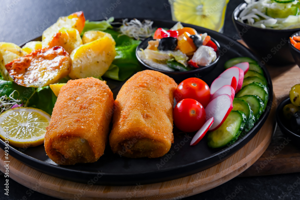 Breaded and deep-fried croquettes with potatoes and vegetables Stock ...