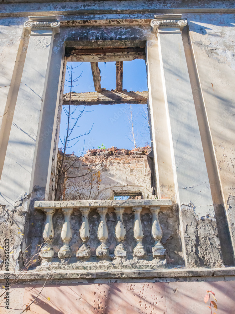 Decorative window opening with columns and balusters in an old ruined ...
