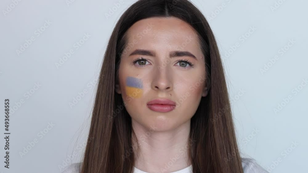 Outdoor portrait of young girl with blue and yellow ukrainian flag on ...