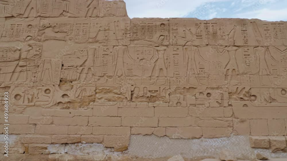 Wall of Karnak Temple Complex with images of hieroglyphs, scenes from ...