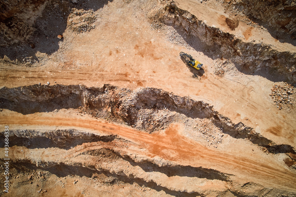 Ledges of a quarry after blasting and drilling operations. Aerial view ...