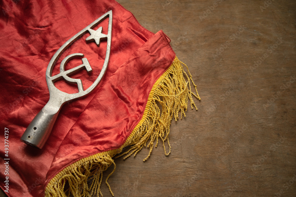 Hammer and sickle on the flagpole.Red flag with yellow tassels from the ...