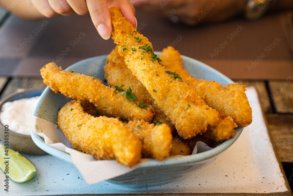 Fresh fried Brazilian tilapia fish strips with lime and tartar sauce ...
