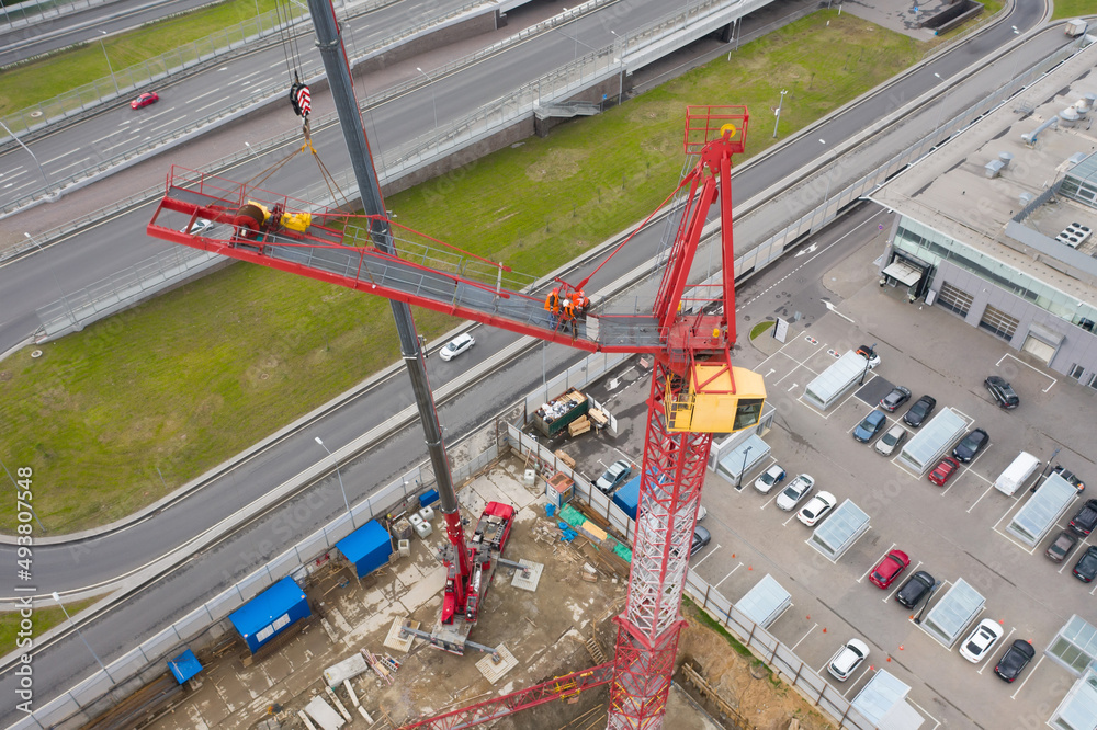 Installing the jib of a construction crane using another crane on the ...