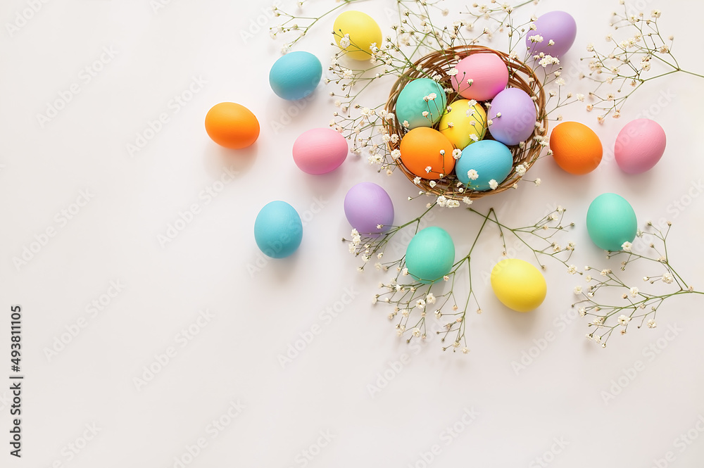 Top view layout of colorful painted Easter eggs with spring flowers on ...