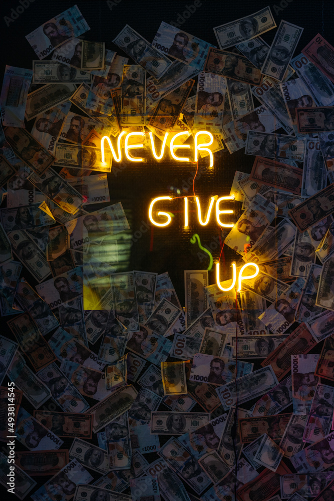 Yellow neon lights background with sign NEVER GIVE UP Stock Photo ...
